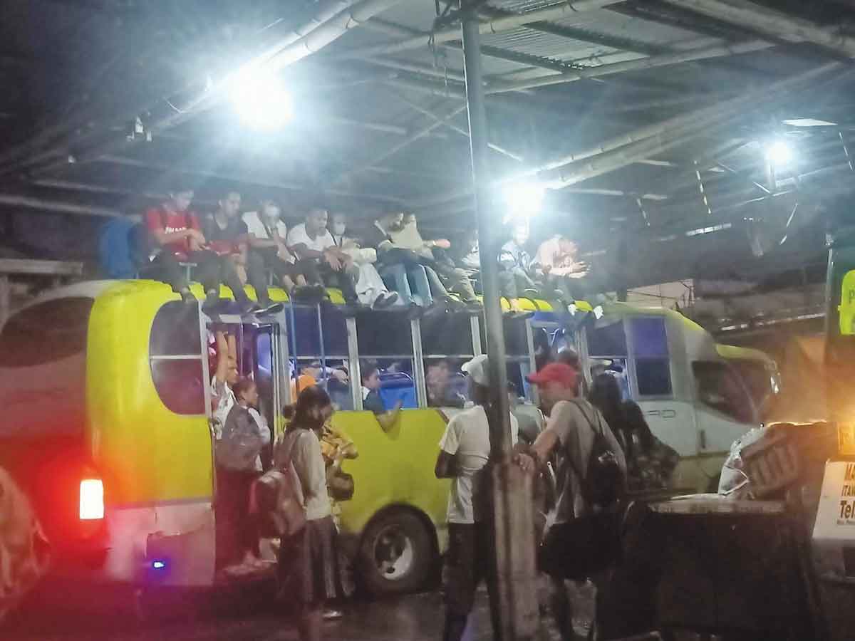 Vallacar Transit statement on yellow bus with passengers seated on the roof